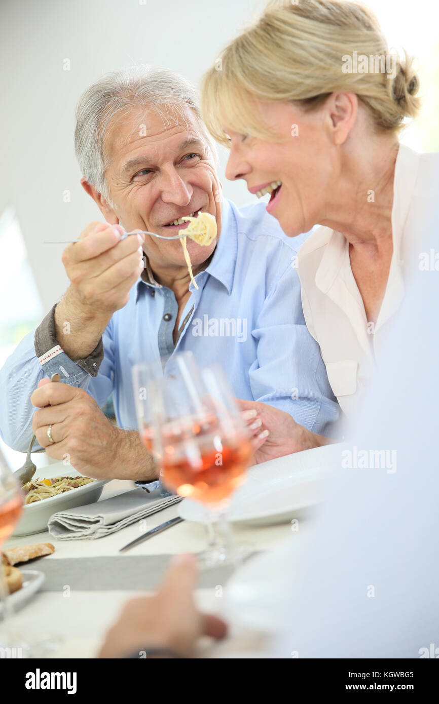 Senior couple sharing pasta at lunch time Stock Photo - Alamy