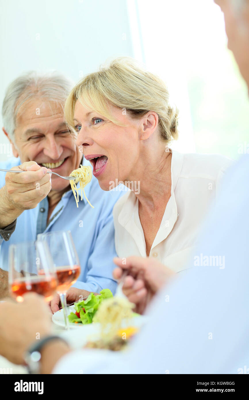 Senior couple sharing pasta at lunch time Stock Photo - Alamy
