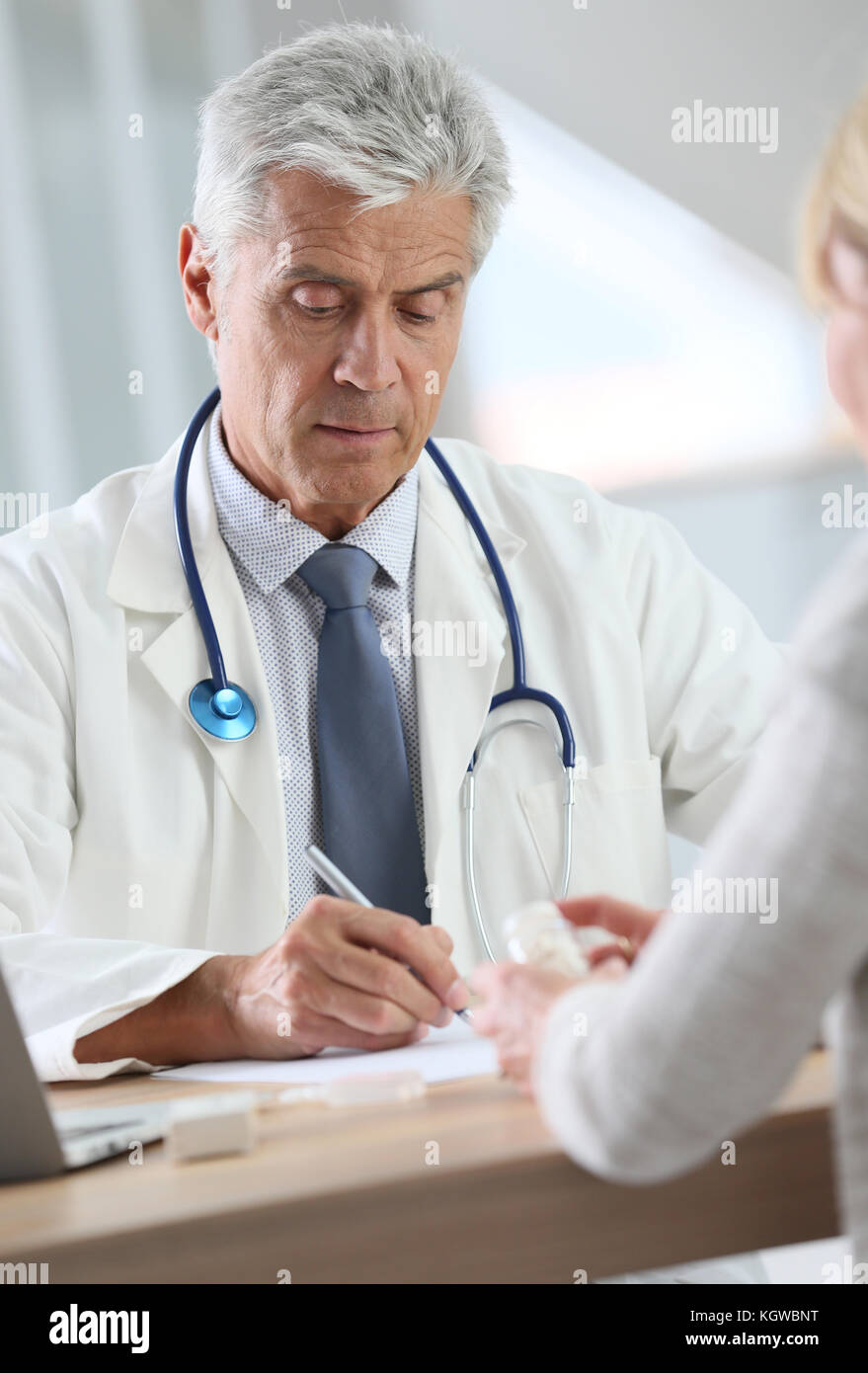 Doctor having consultation with patient in office Stock Photo - Alamy