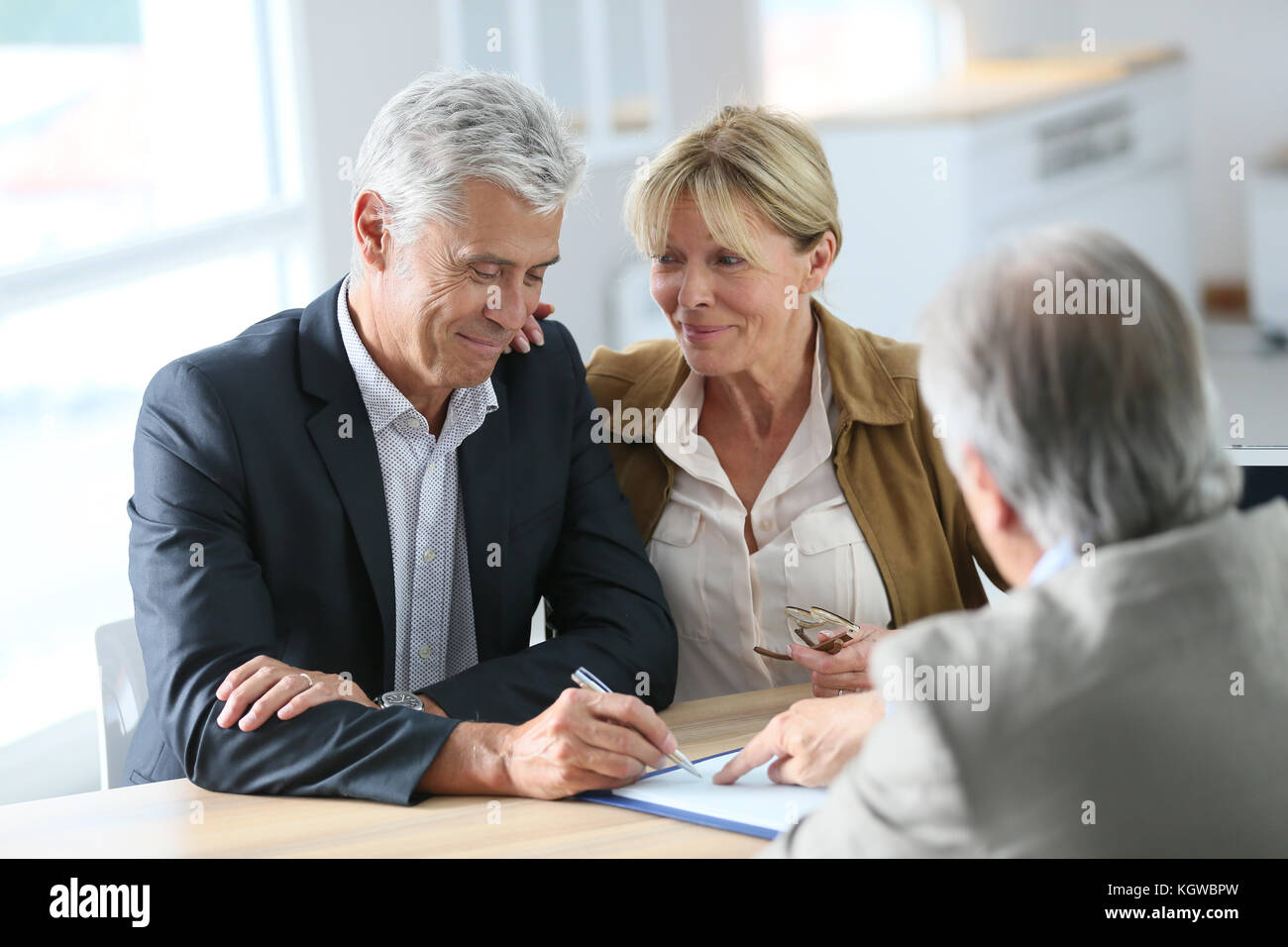 Senior couple meeting real-estate agent for investment Stock Photo - Alamy