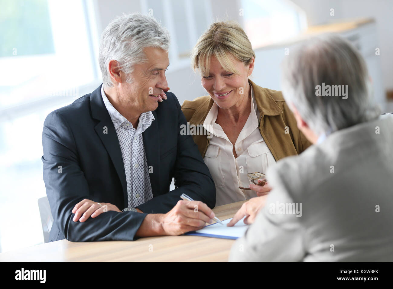 Senior couple meeting real-estate agent for investment Stock Photo - Alamy