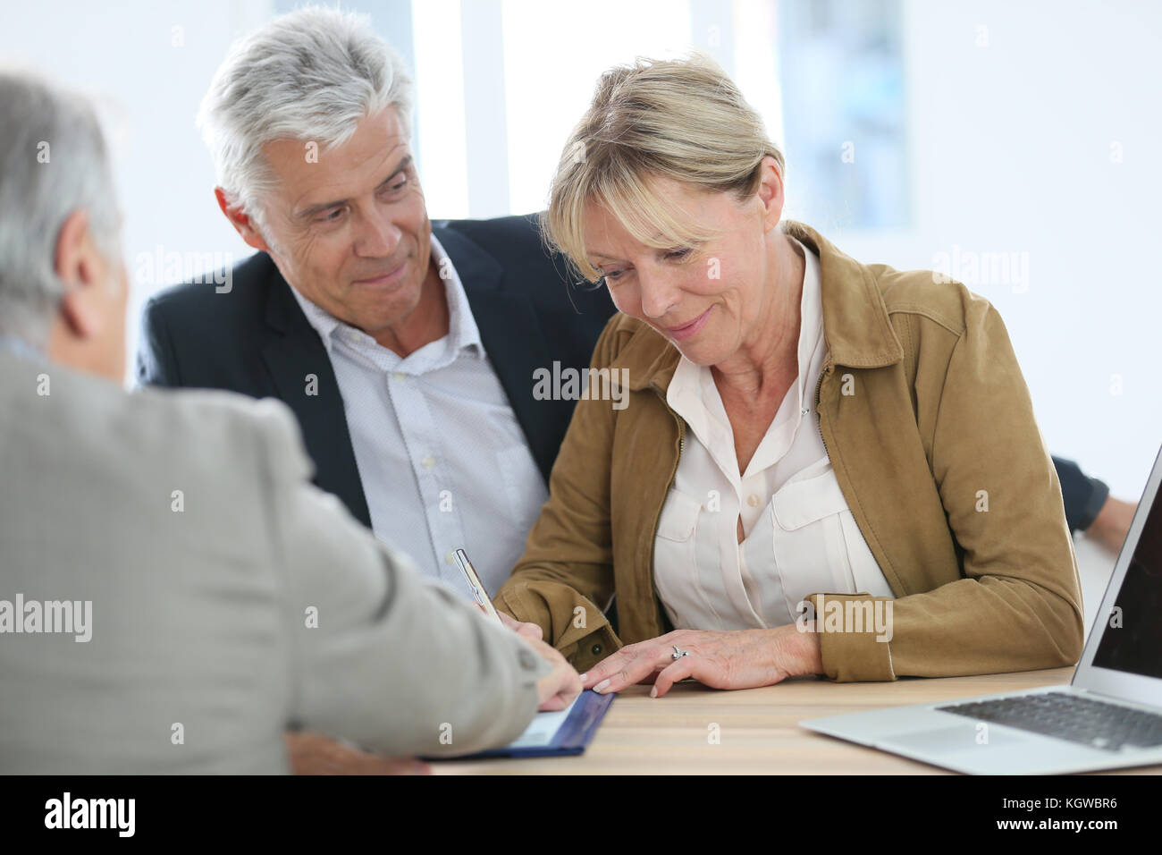 Senior couple meeting real-estate agent for investment Stock Photo - Alamy