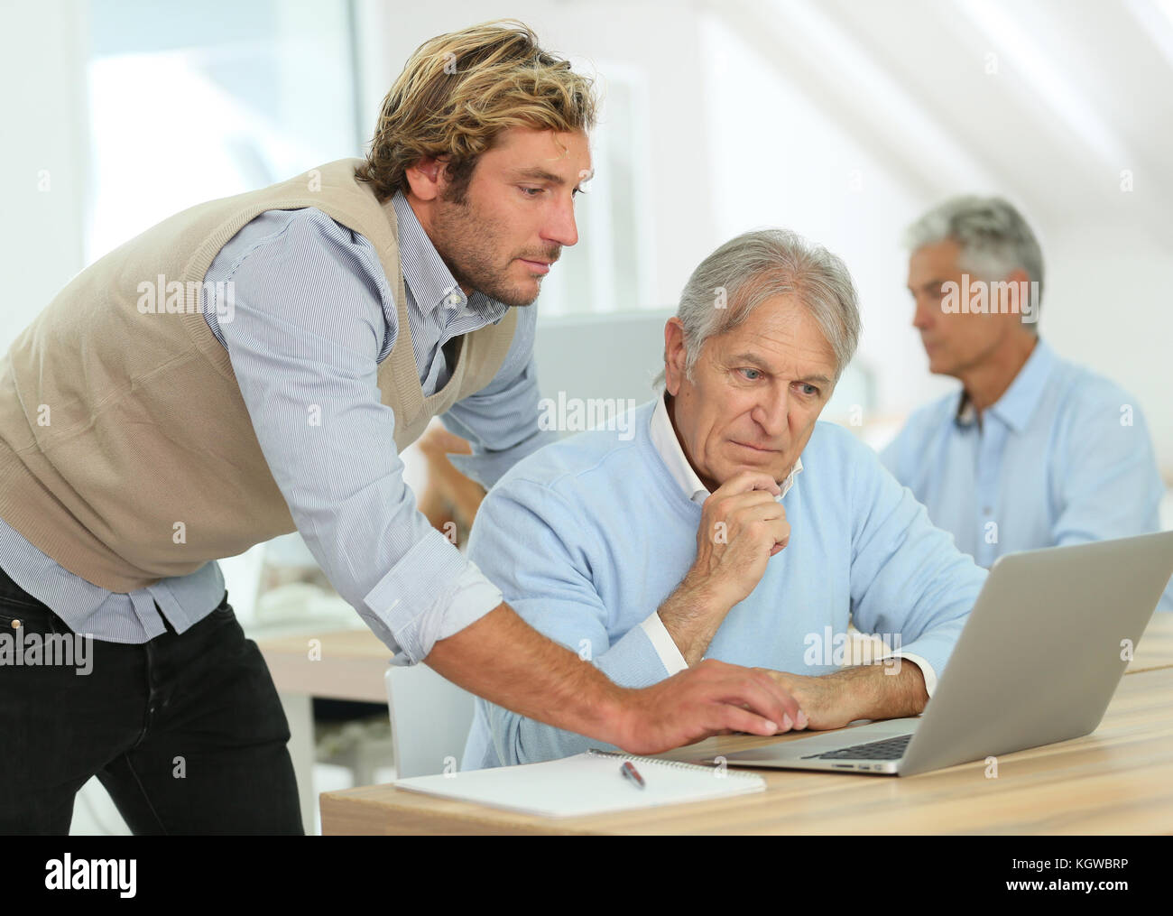 Senior man attending business class with trainer Stock Photo - Alamy