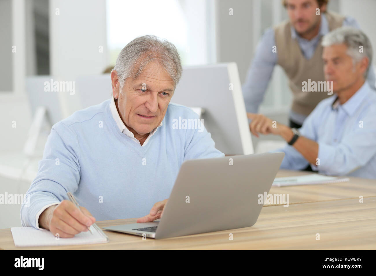 Portrait of senior man working on laptop, training class Stock Photo ...