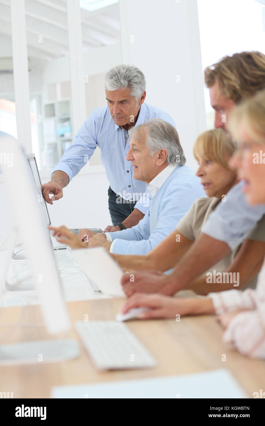 Group of senior people in business training class Stock Photo - Alamy