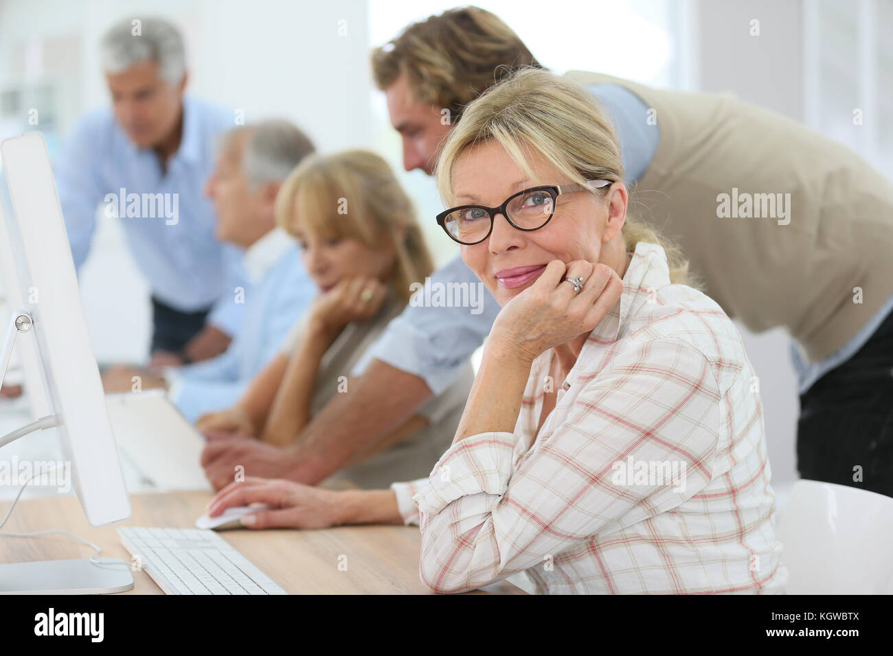 Senior woman attending training business class Stock Photo - Alamy