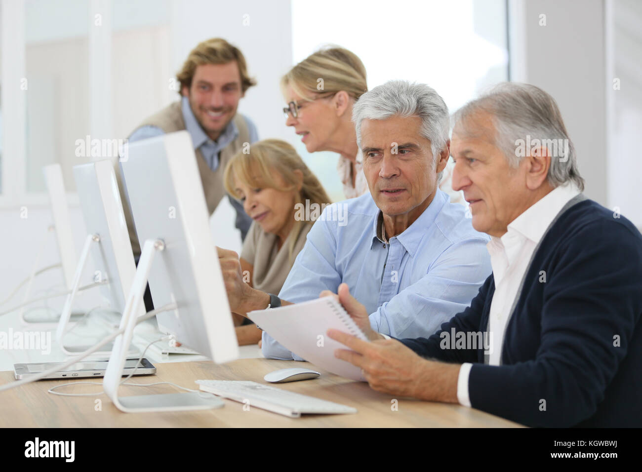 Group of senior people in business training class Stock Photo - Alamy