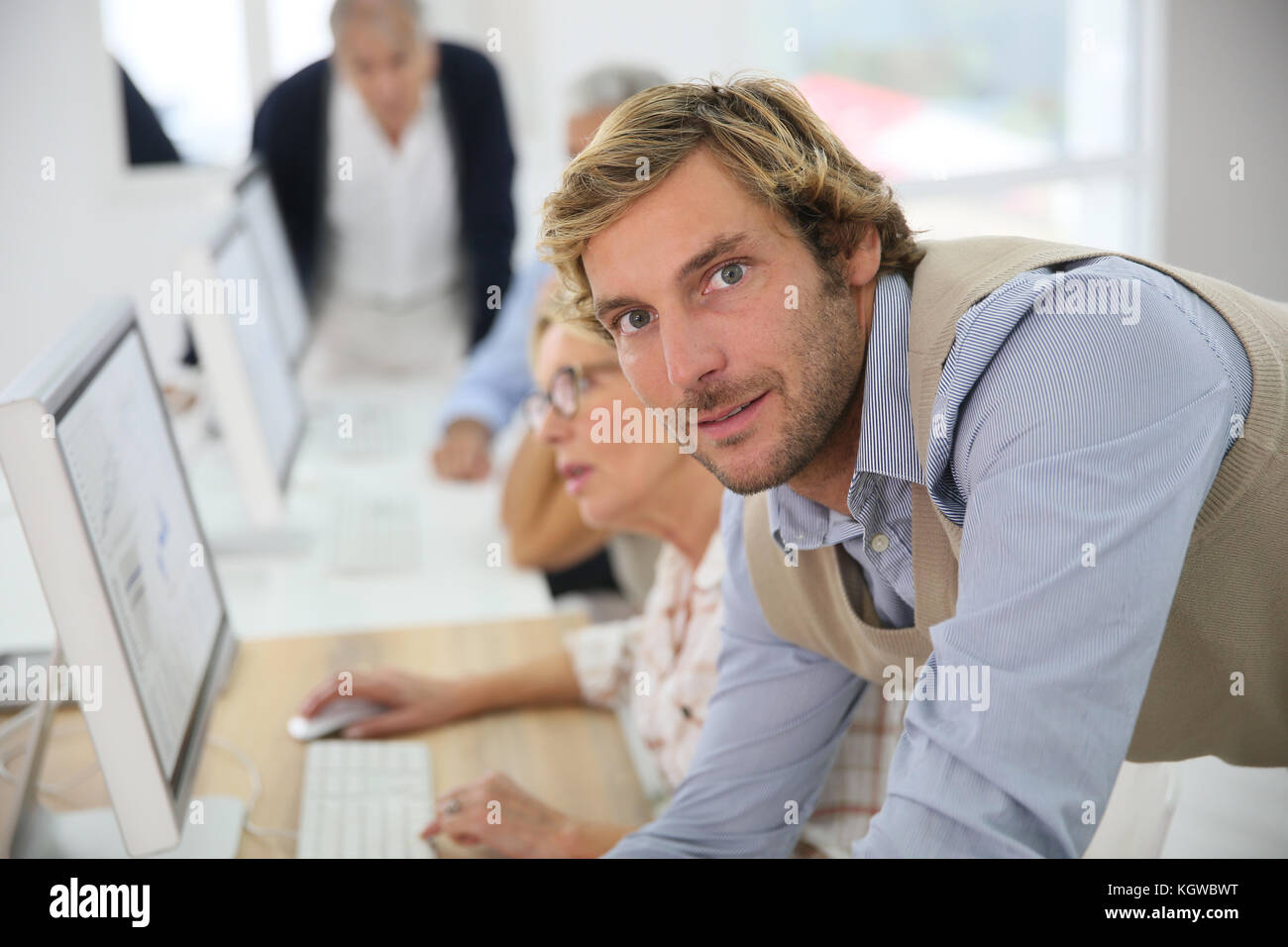Portrait of young instructor in business class Stock Photo - Alamy