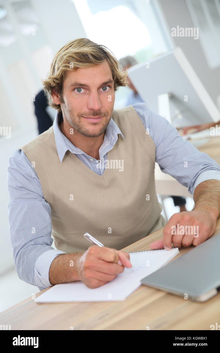 Portrait of young instructor in business class Stock Photo - Alamy