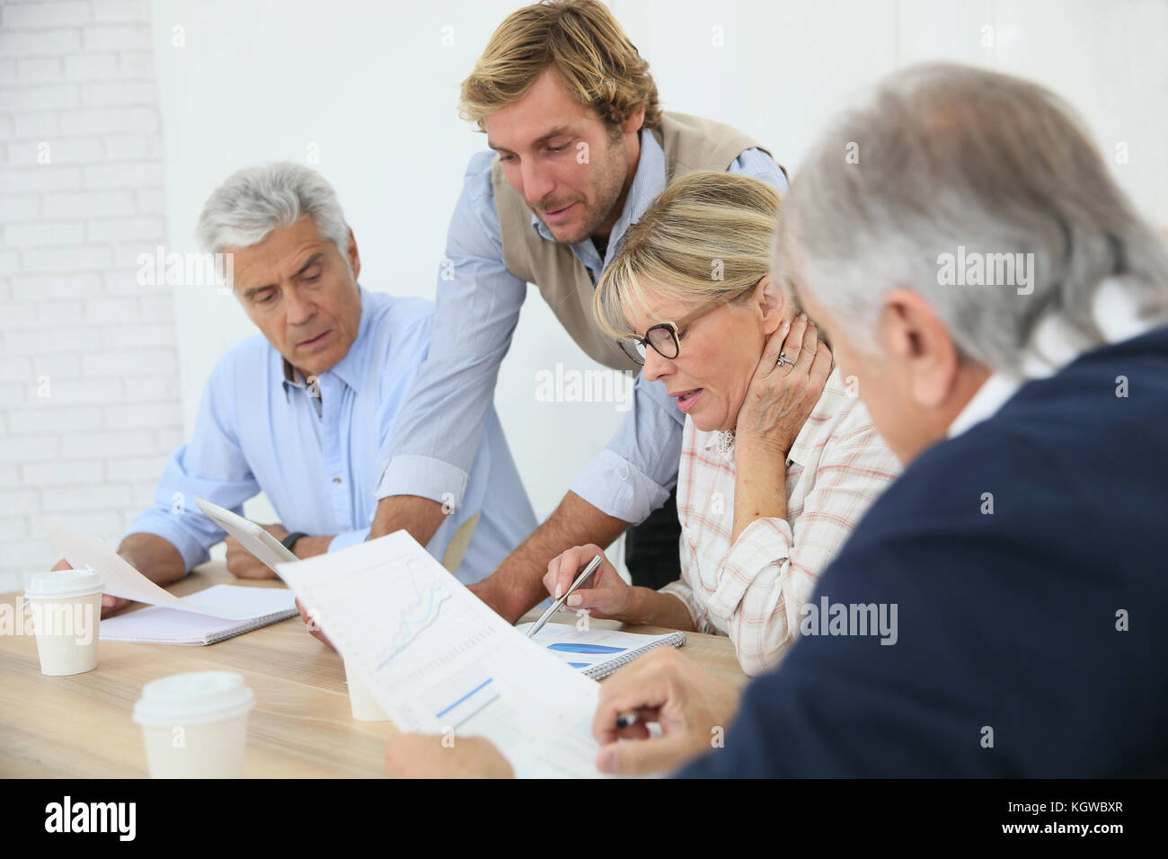 Business instructor with group of senior people Stock Photo - Alamy