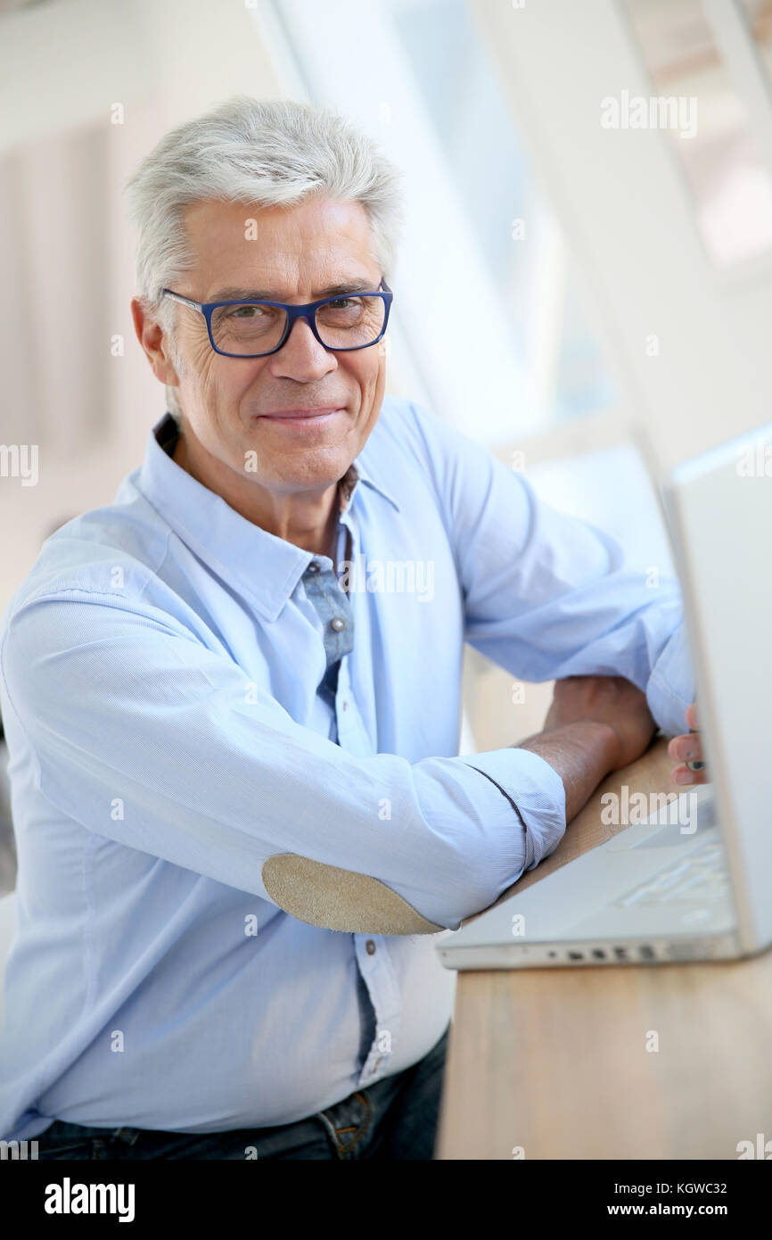 Senior businessman working on laptop computer Stock Photo - Alamy