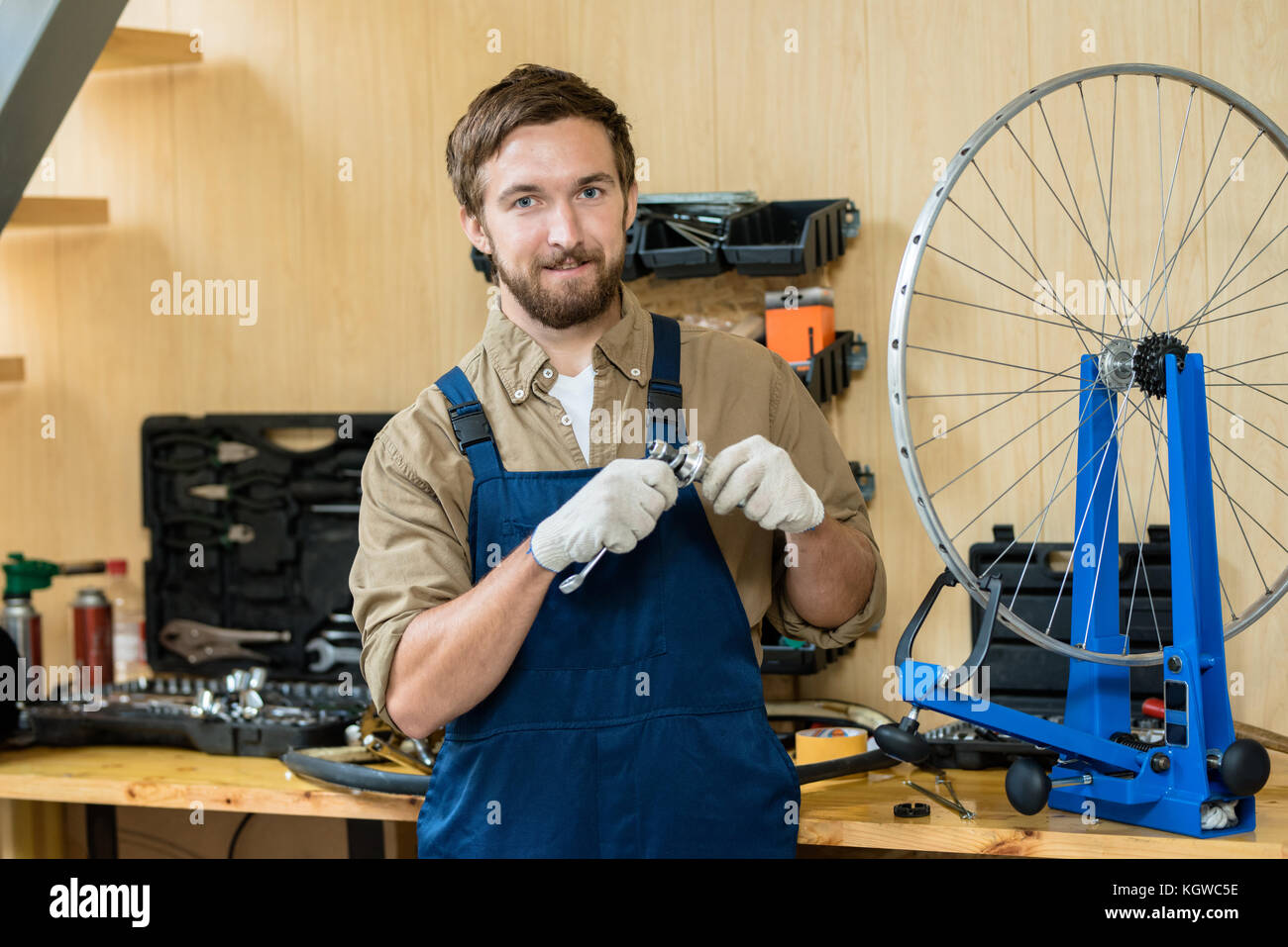 Successful specialist of repair looking at camera in his workshop Stock ...