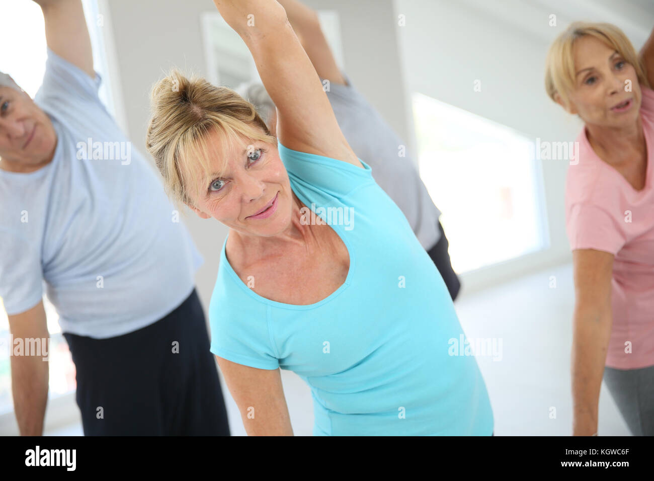 Senior people stretching out in fitness room Stock Photo - Alamy
