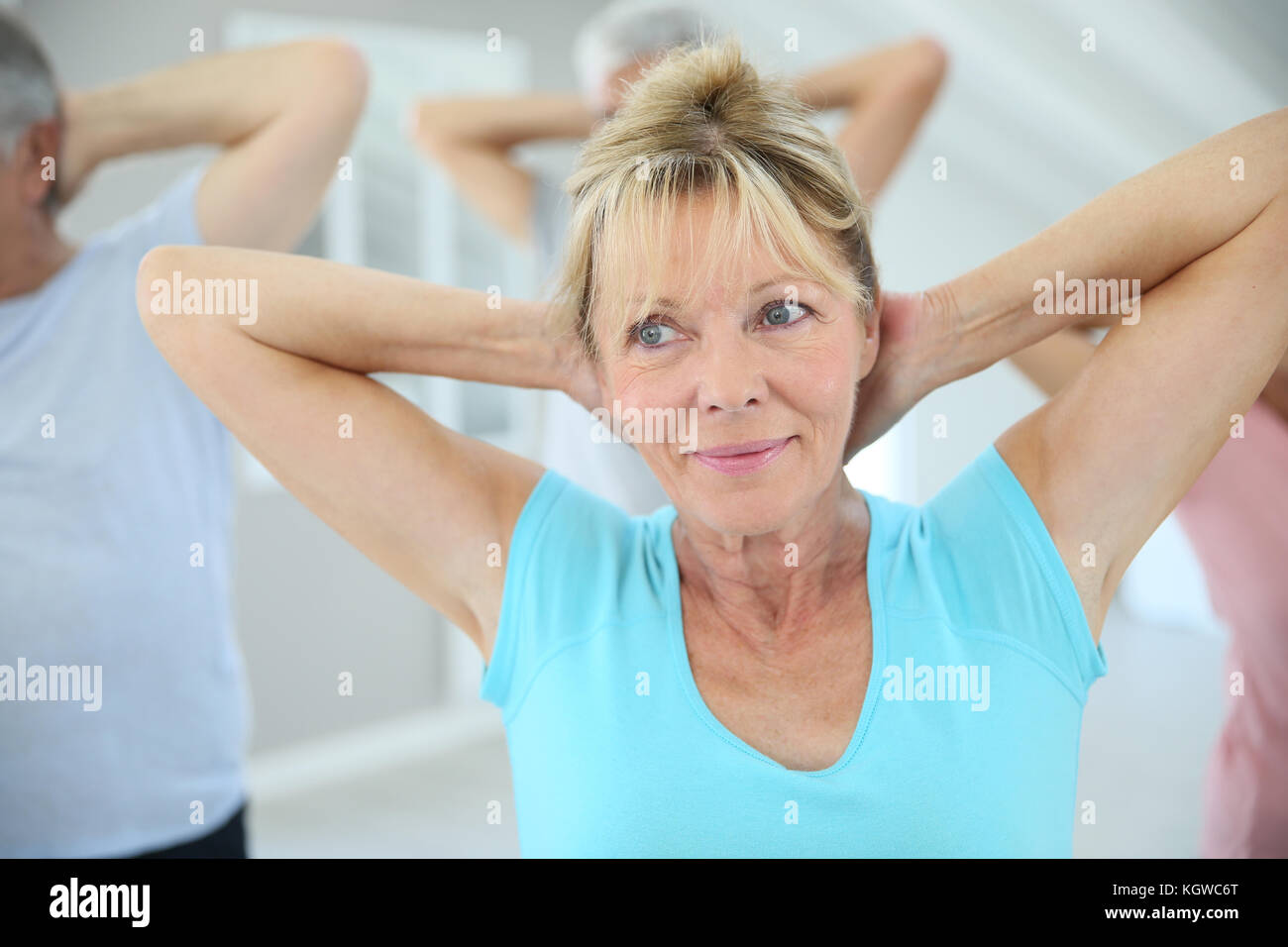 Senior people stretching out in fitness room Stock Photo - Alamy