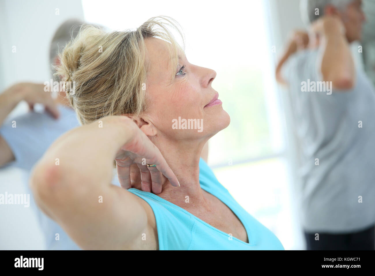 Senior people stretching out in fitness room Stock Photo - Alamy