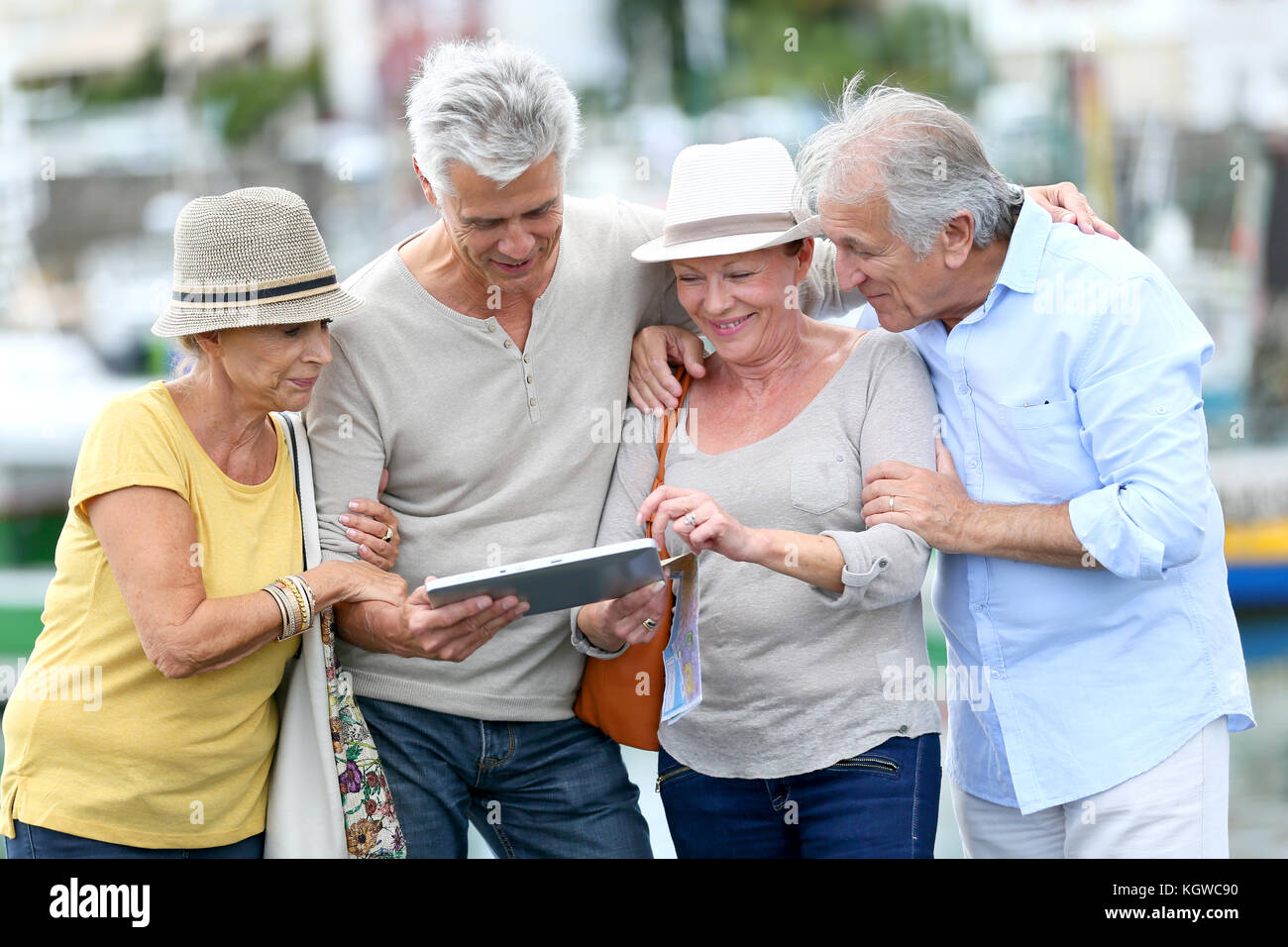 Senior tourists using tablet on visiting journey Stock Photo - Alamy