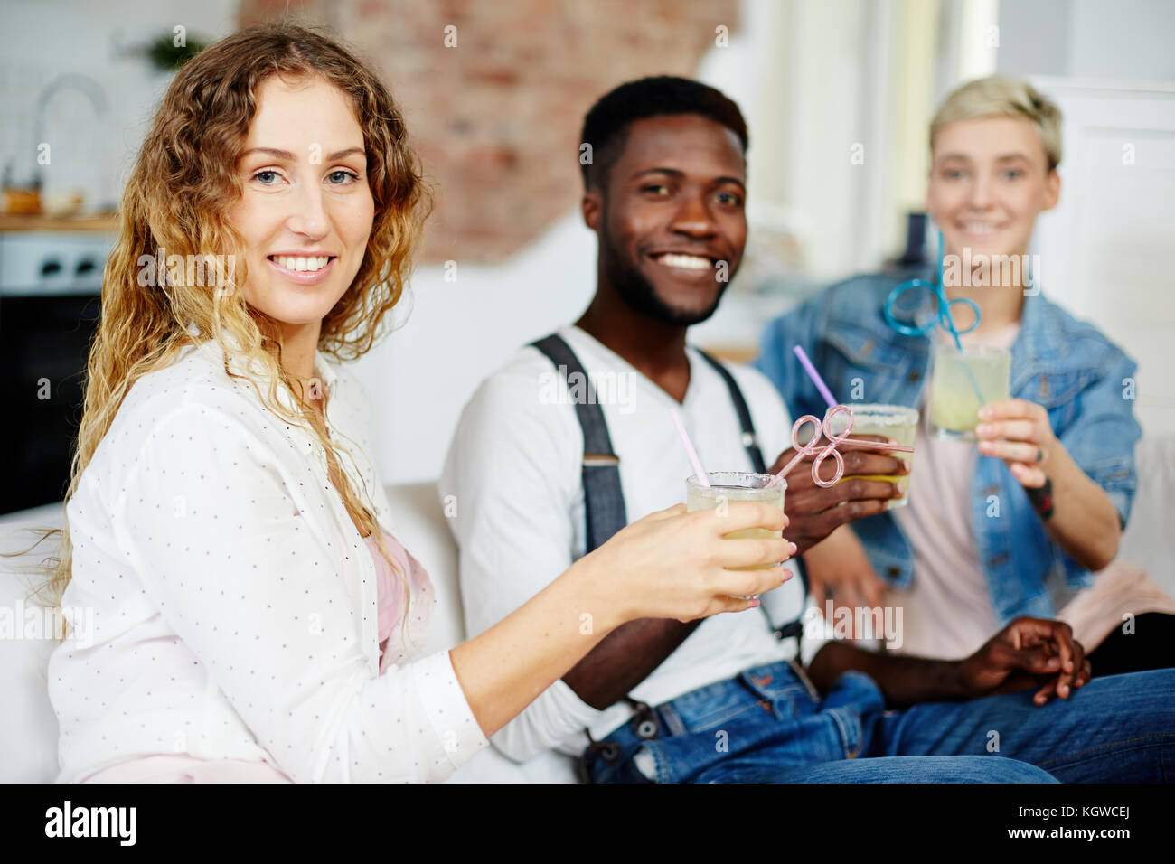 Gathering of intercultural friends at cocktail home party Stock Photo ...