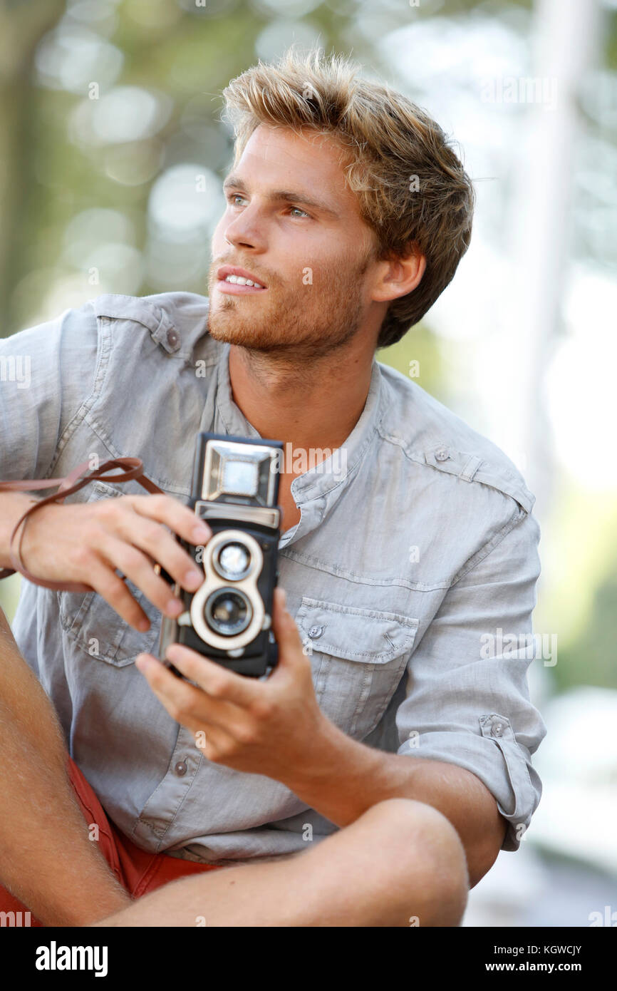 Trendy photographer using vintage camera Stock Photo - Alamy