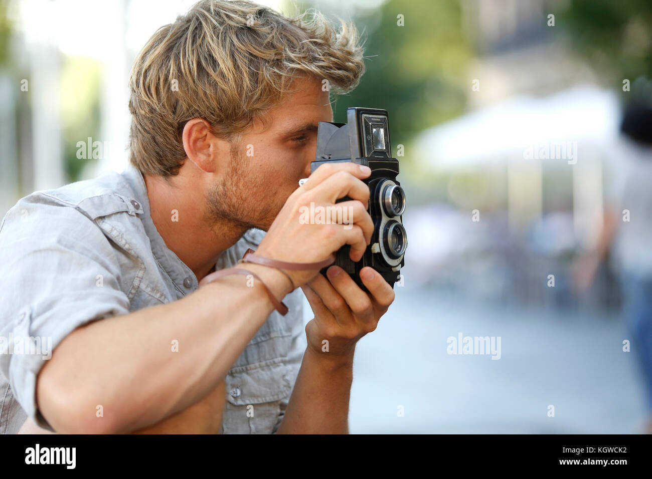 Trendy photographer using vintage camera Stock Photo - Alamy
