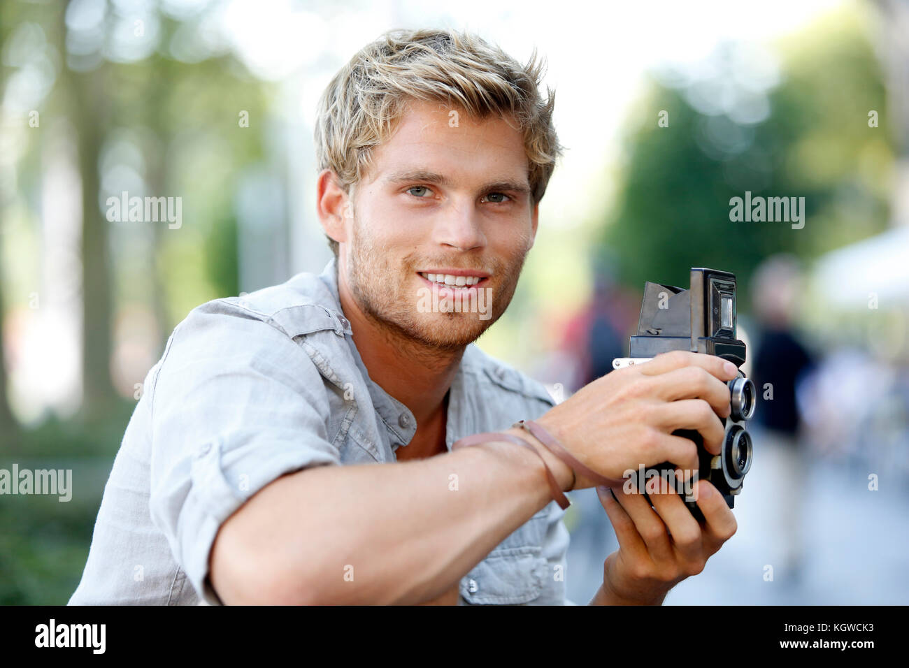 Trendy photographer using vintage camera Stock Photo - Alamy