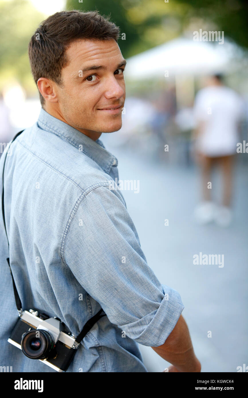 Smiling man photographing with vintage camera Stock Photo - Alamy