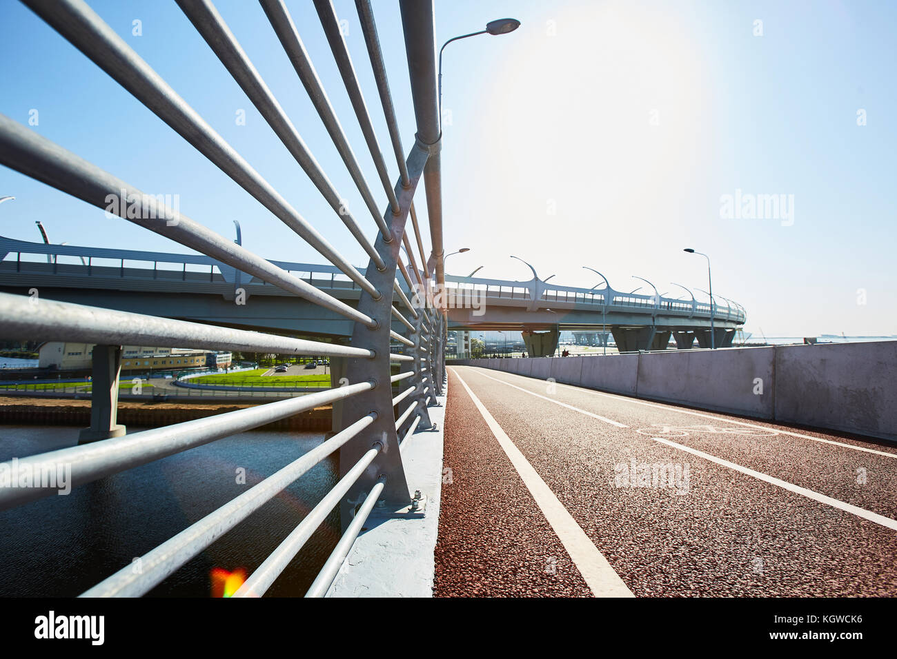 Race track of modern stadium and bridge railings over waterside Stock ...