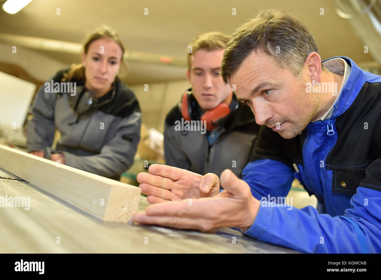 Carpenter instructor with students in workshop Stock Photo - Alamy