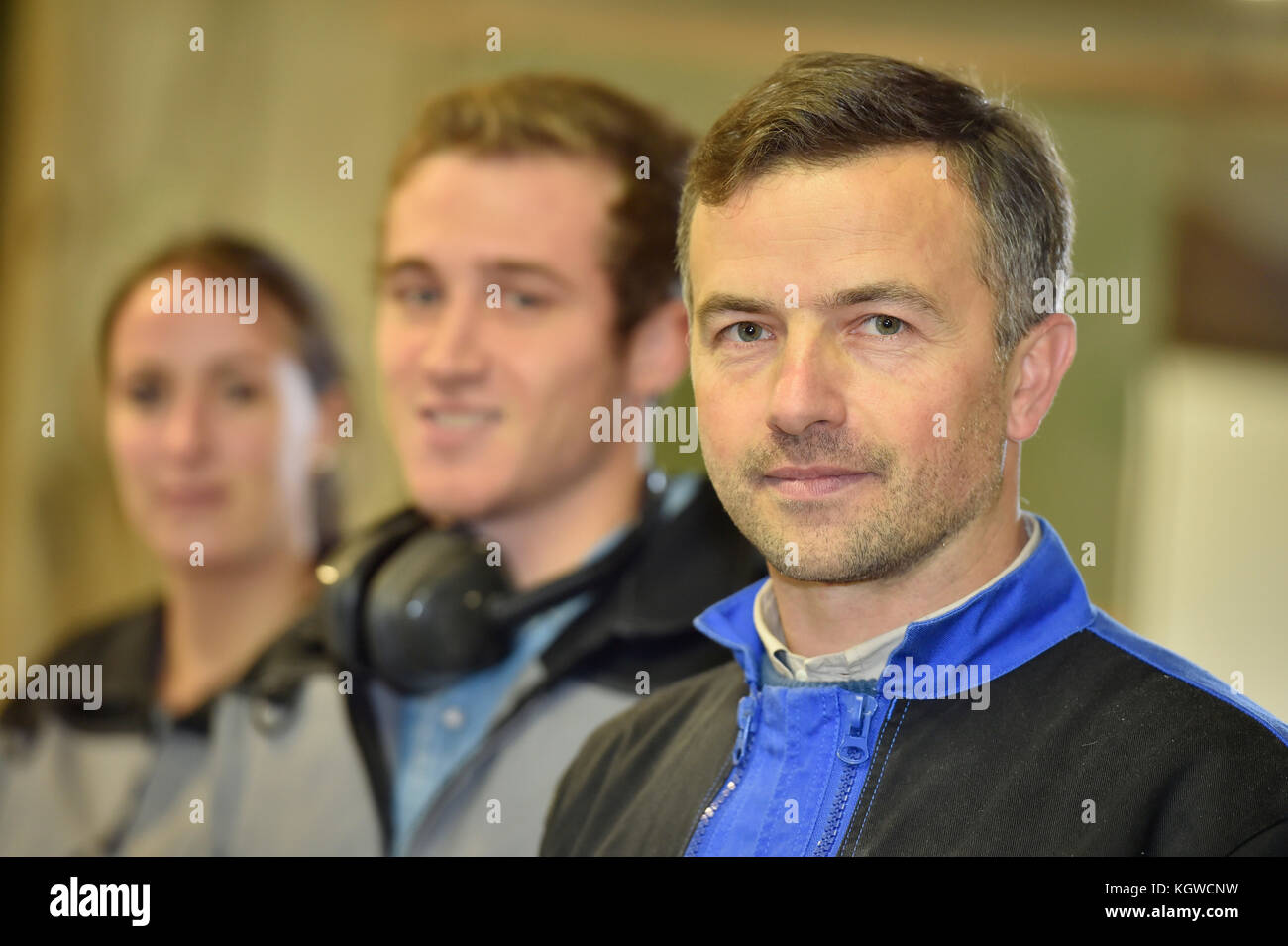 Portrait of carpentry trainer with students in background Stock Photo ...