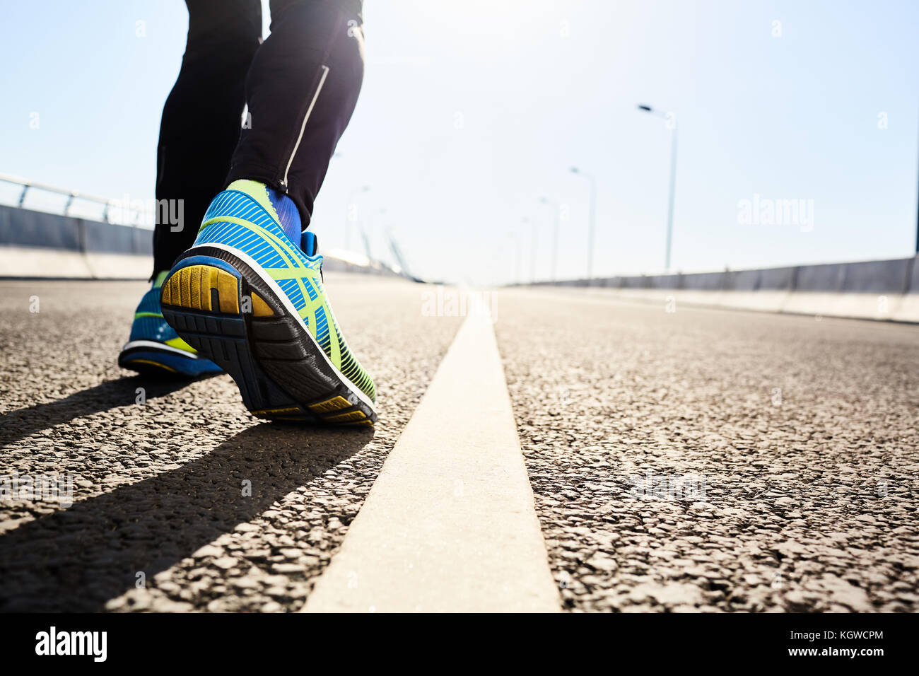 Feet of active man during morning workout on urban road Stock Photo - Alamy