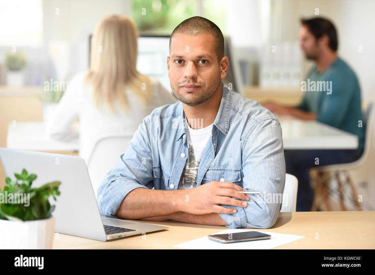 Man in office working on laptop computer Stock Photo - Alamy