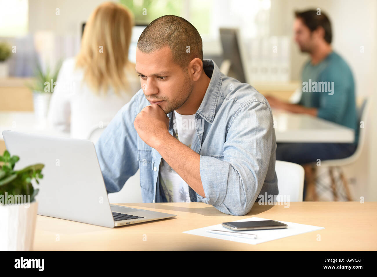 Man in office working on laptop computer Stock Photo - Alamy