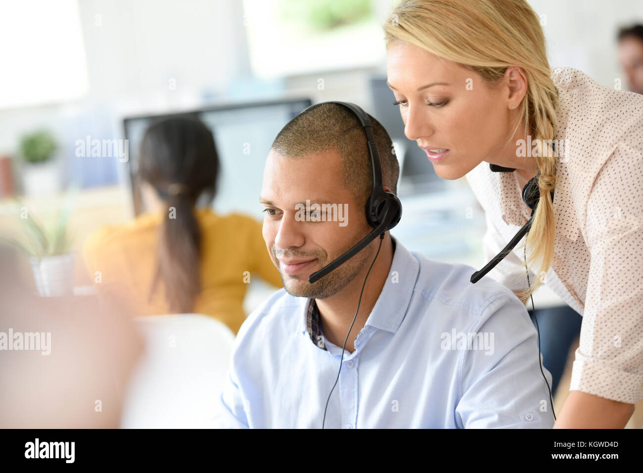 Teleoperator in office with manager Stock Photo - Alamy