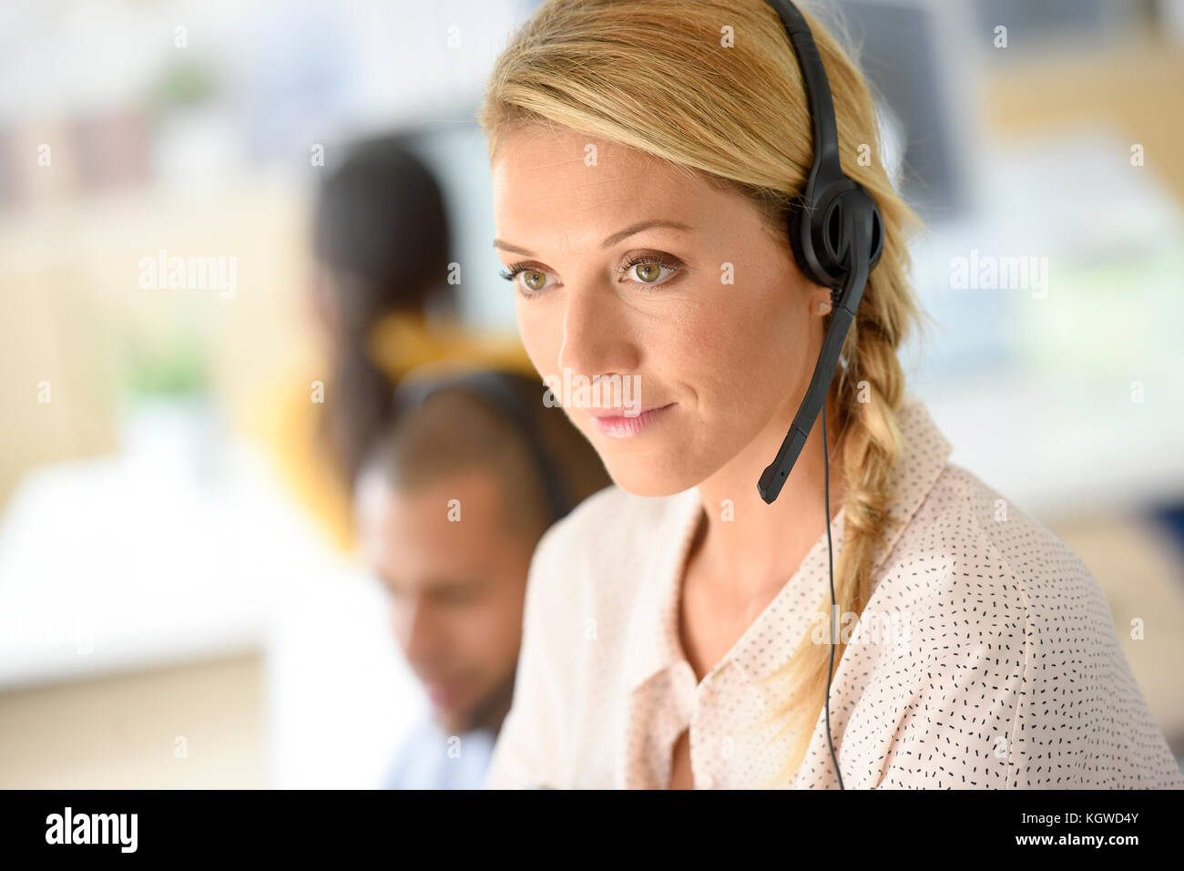 Closeup of customer service manager standing in call center Stock Photo ...