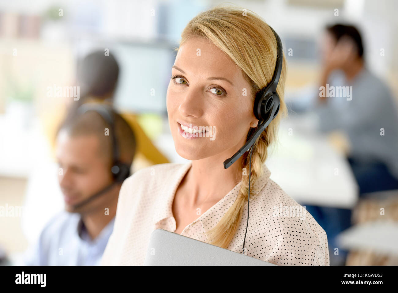 Closeup of customer service manager standing in call center Stock Photo ...