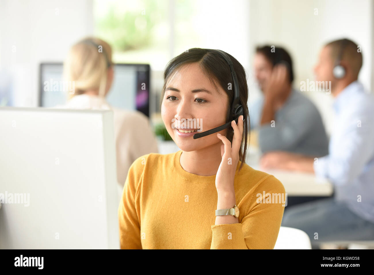 Customer service assistant working in office Stock Photo - Alamy