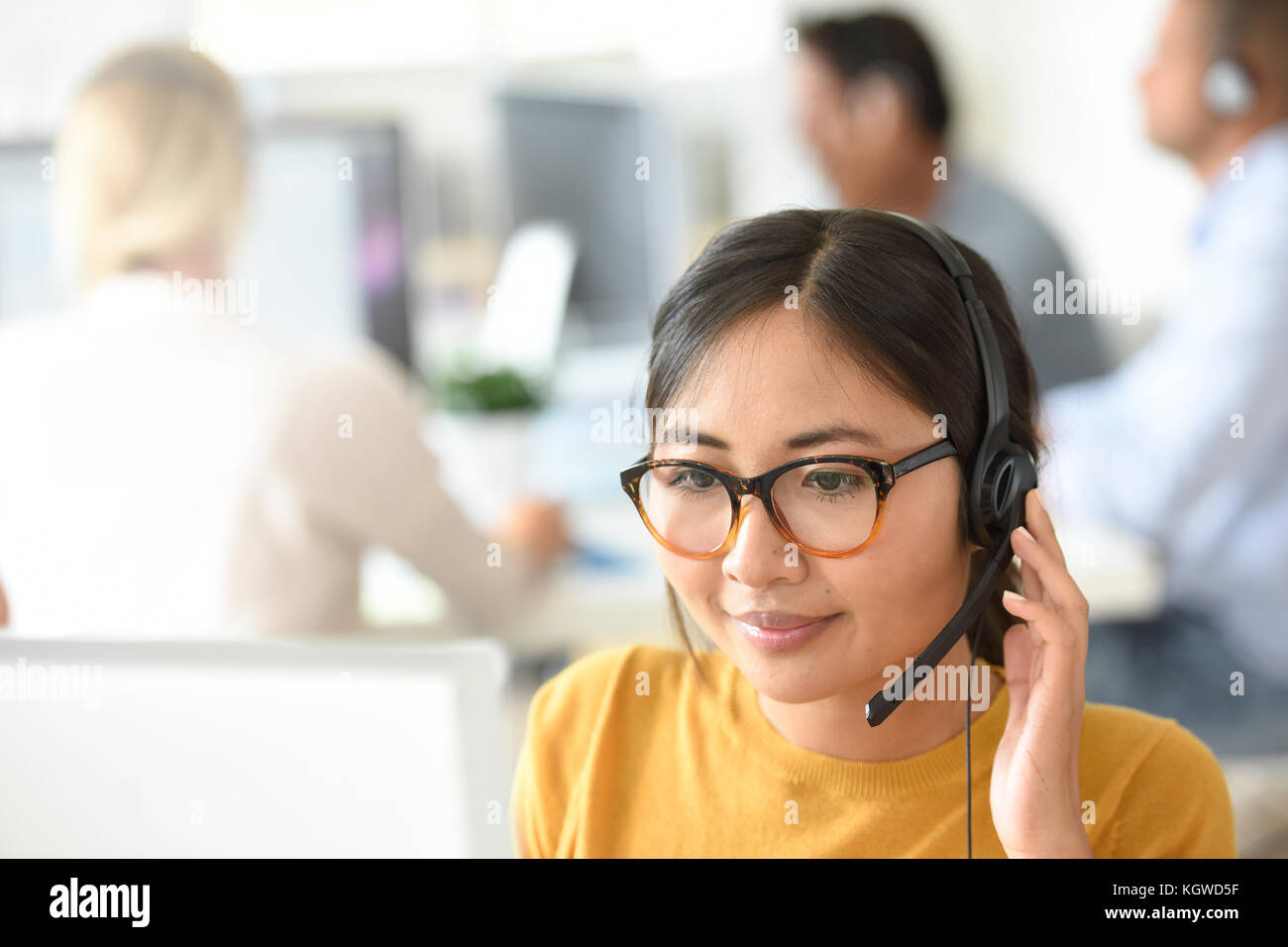 Customer service assistant working in office Stock Photo - Alamy