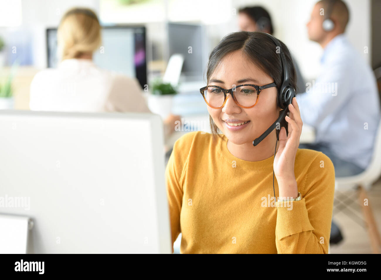 Customer service assistant working in office Stock Photo - Alamy