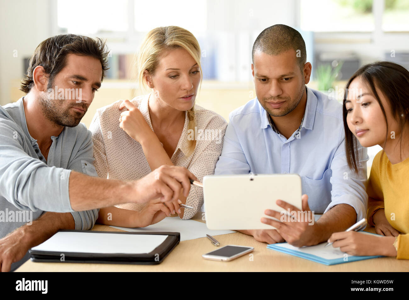 Business people meeting around table in office Stock Photo - Alamy
