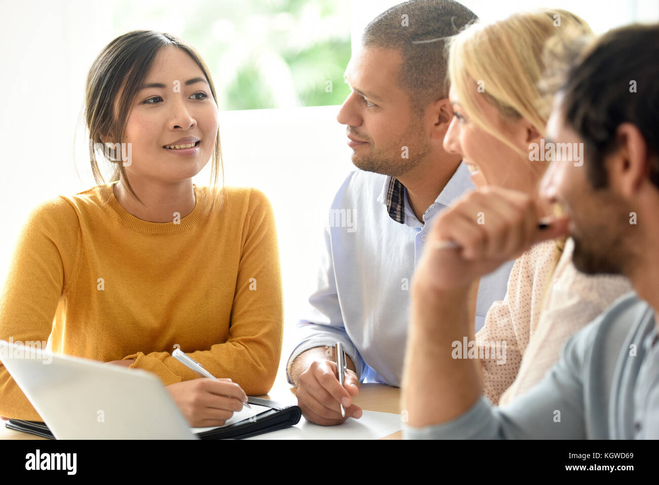 Business workgroup interacting in office Stock Photo - Alamy