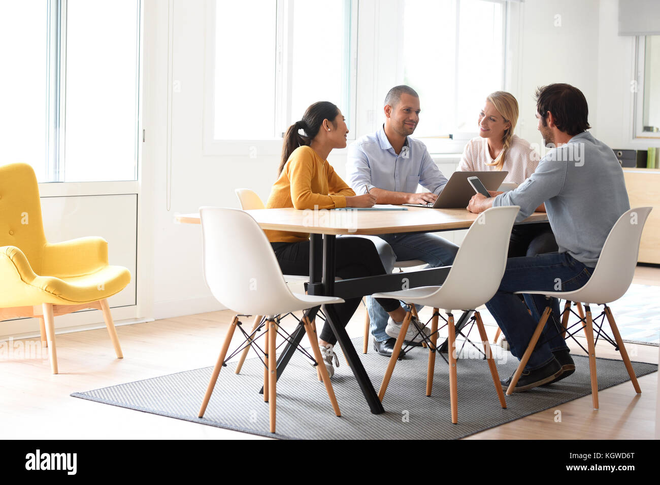 Business people meeting around table in office Stock Photo - Alamy
