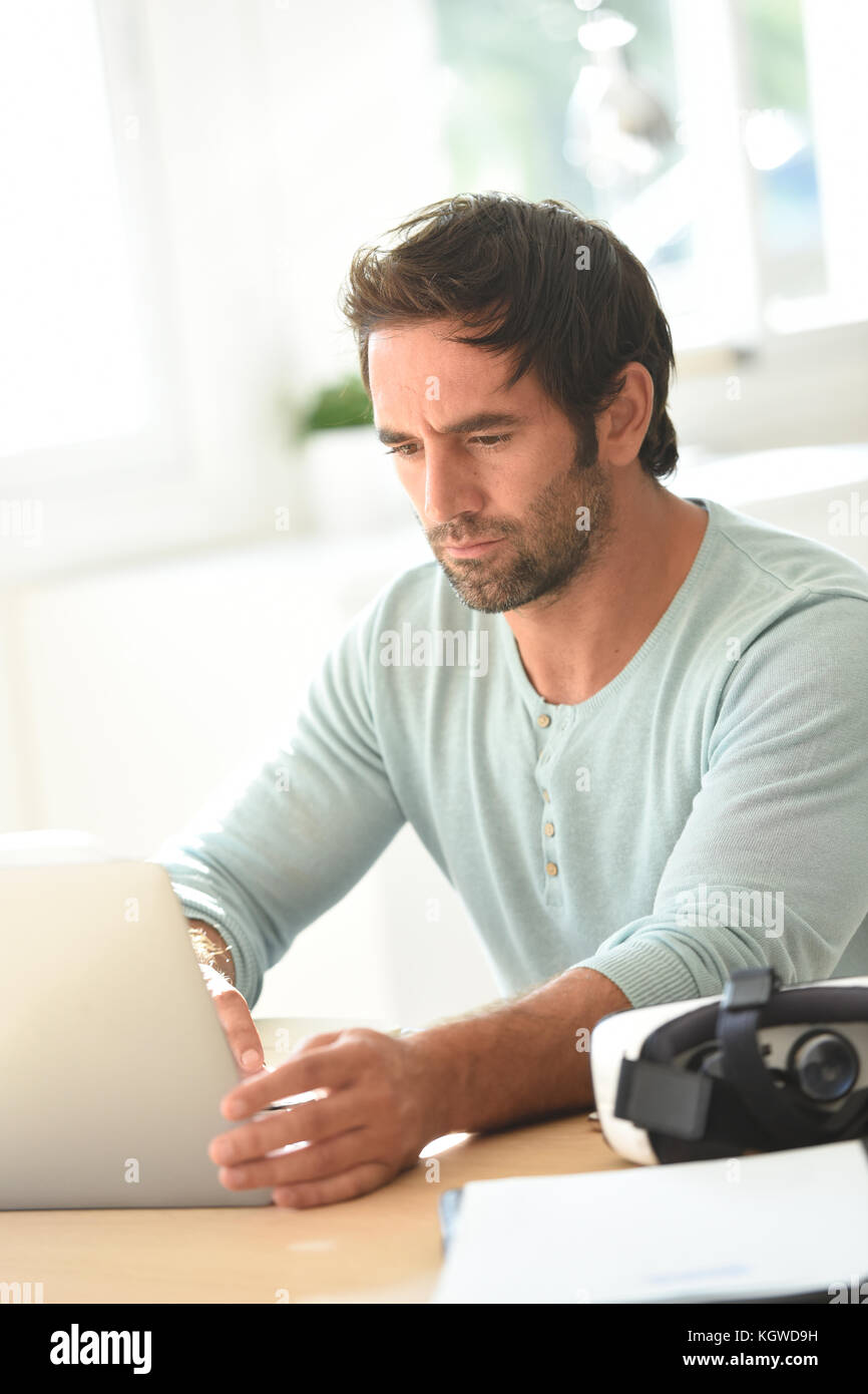 Man in office working on laptop Stock Photo - Alamy
