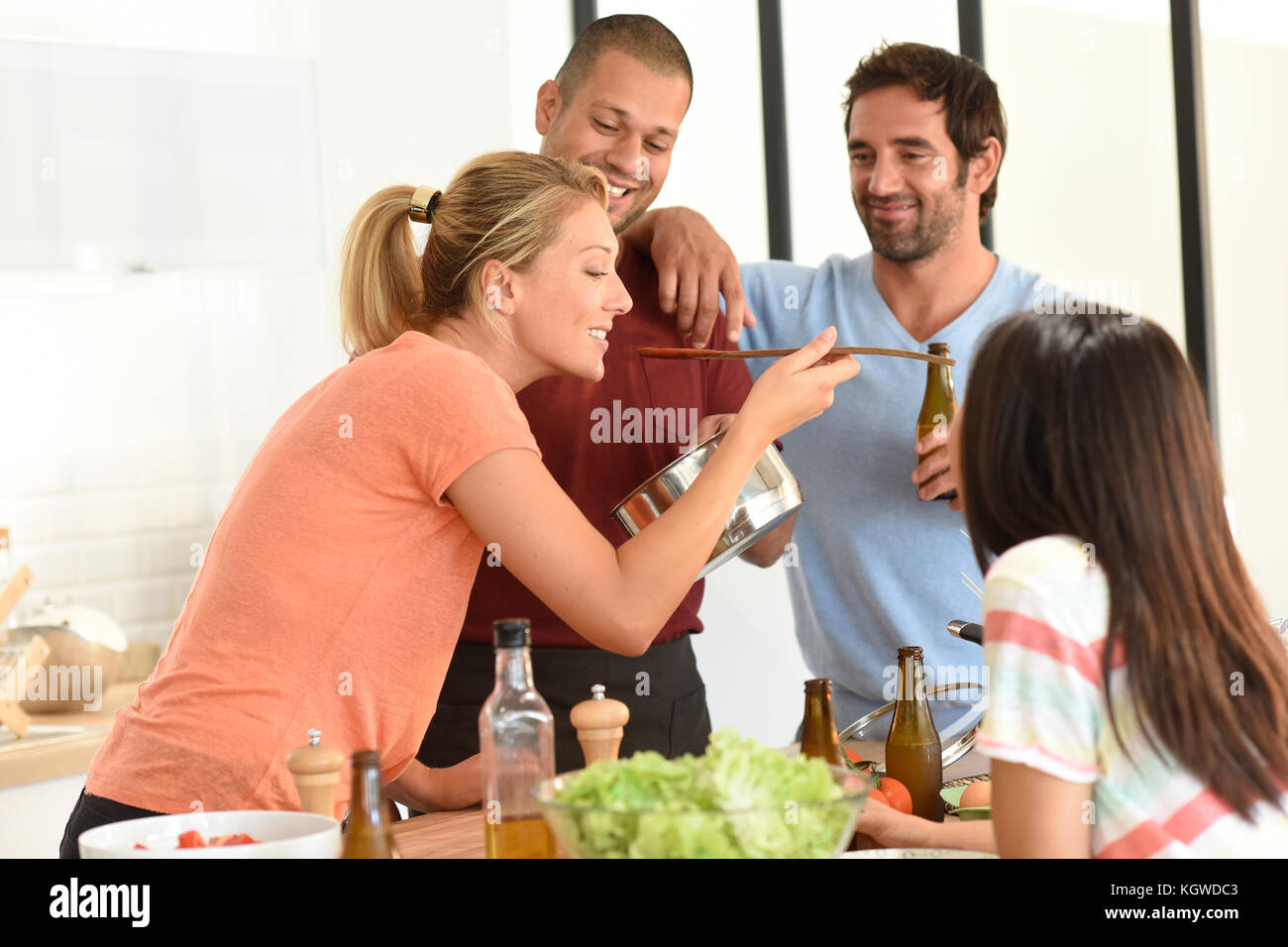 Friends having fun cooking together Stock Photo - Alamy