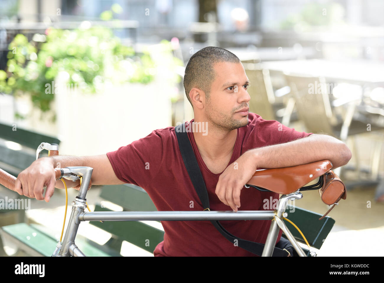 Man with bicycle sitting on park bench Stock Photo - Alamy