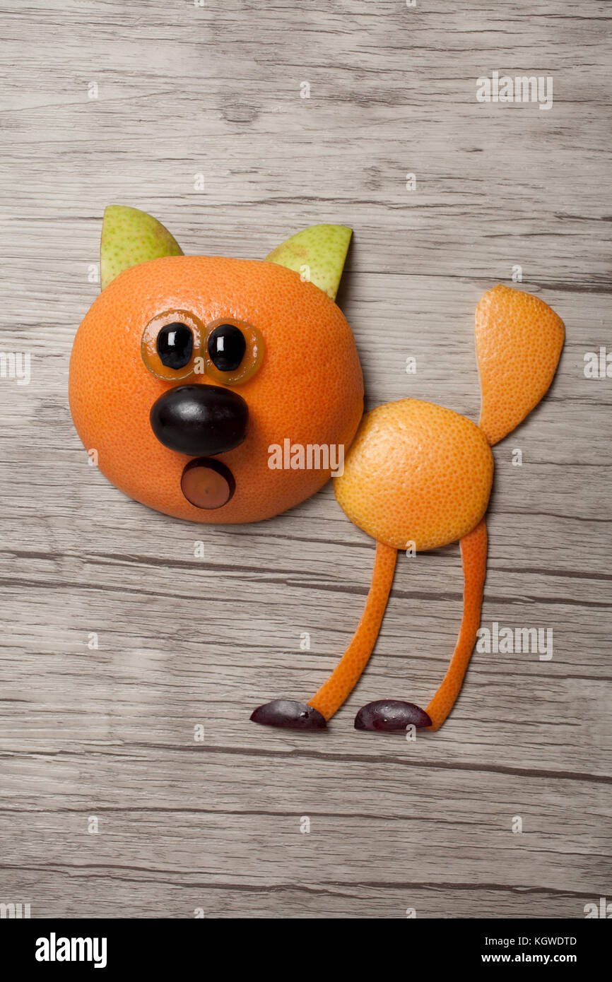 Cat made with orange on wooden background Stock Photo - Alamy