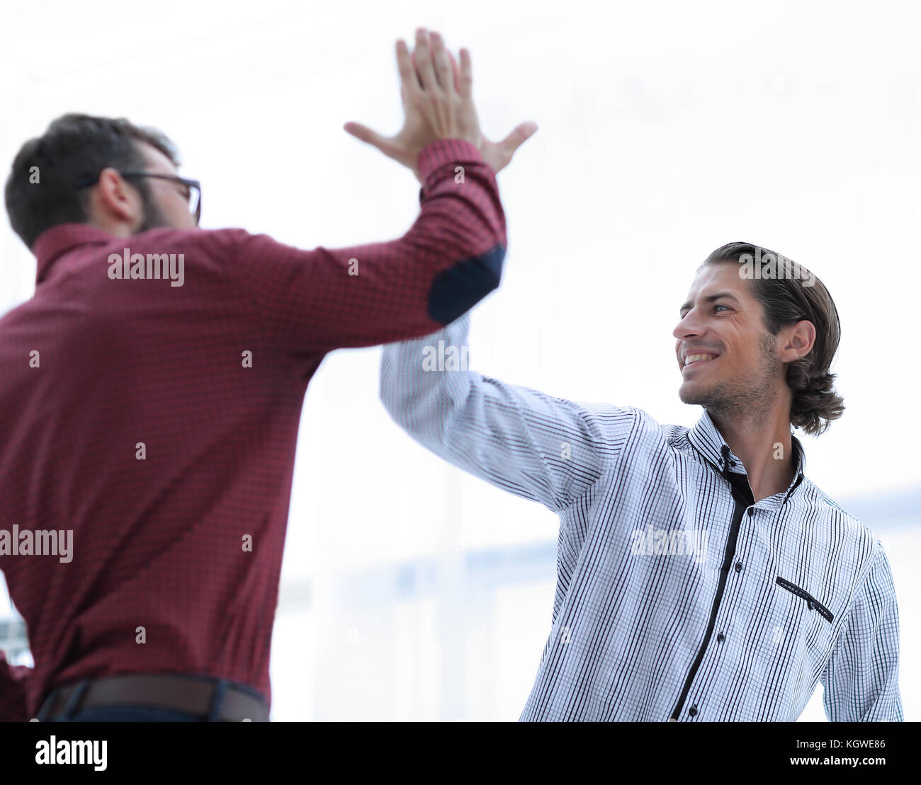 two business men giving each other a high five Stock Photo - Alamy