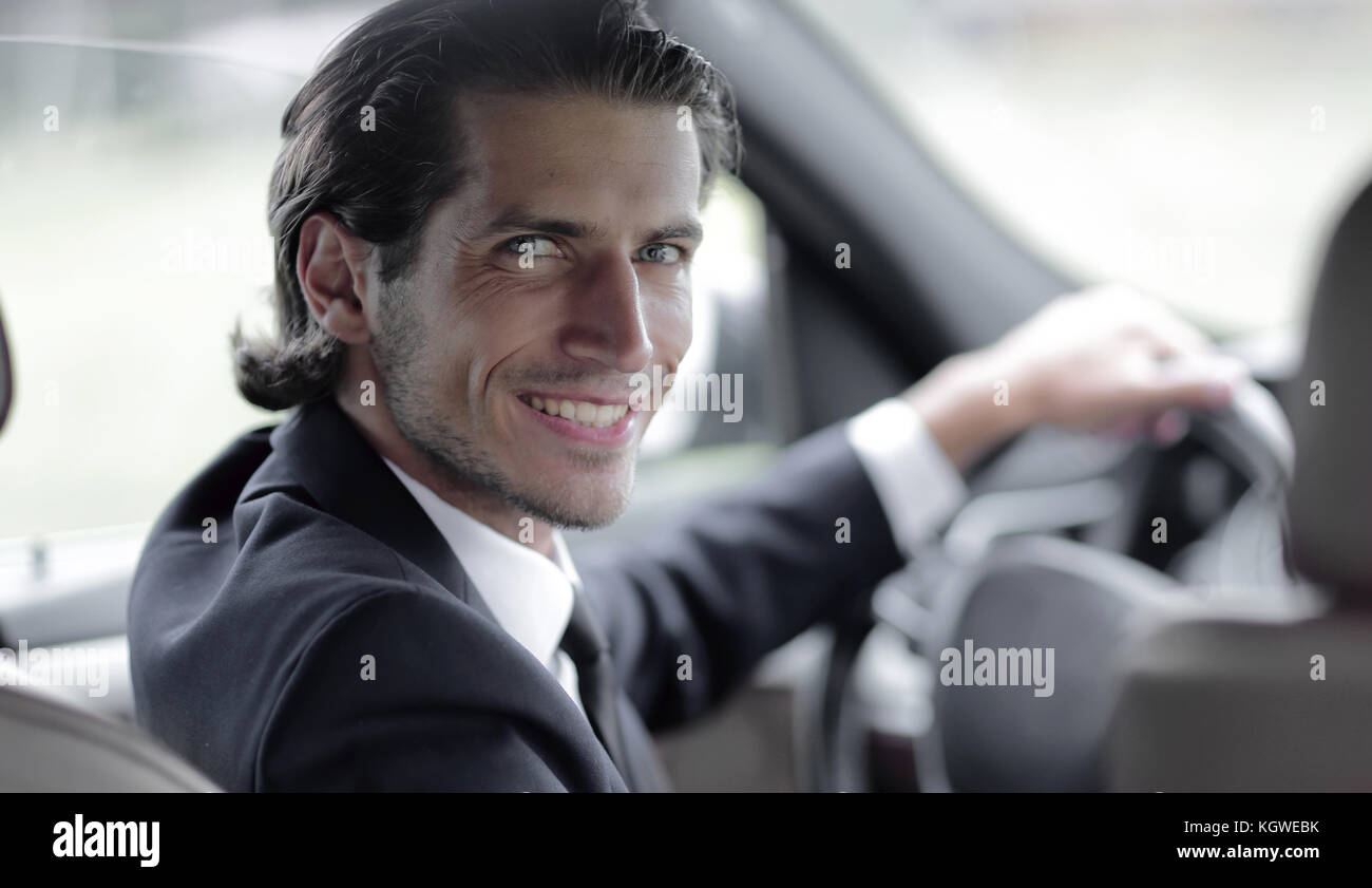 man sitting behind the wheel of a car Stock Photo - Alamy