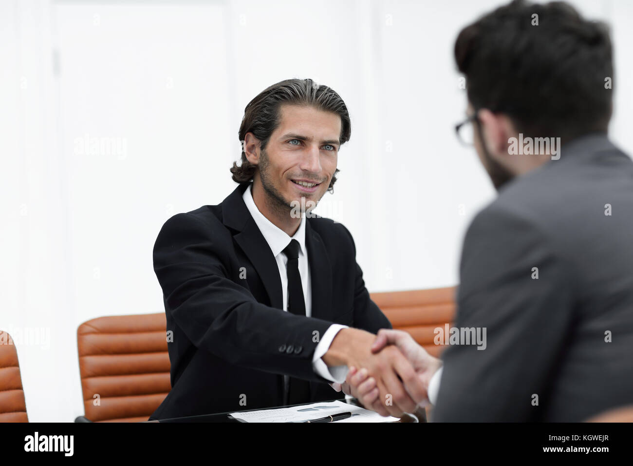 handshake Manager and the client sitting in the office Stock Photo - Alamy