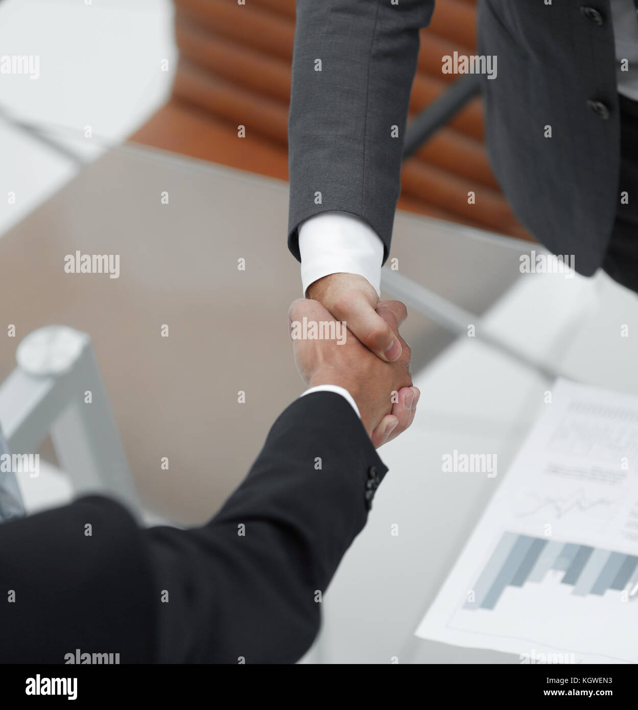 handshake of business partners sitting at their Desk.photo with copy ...