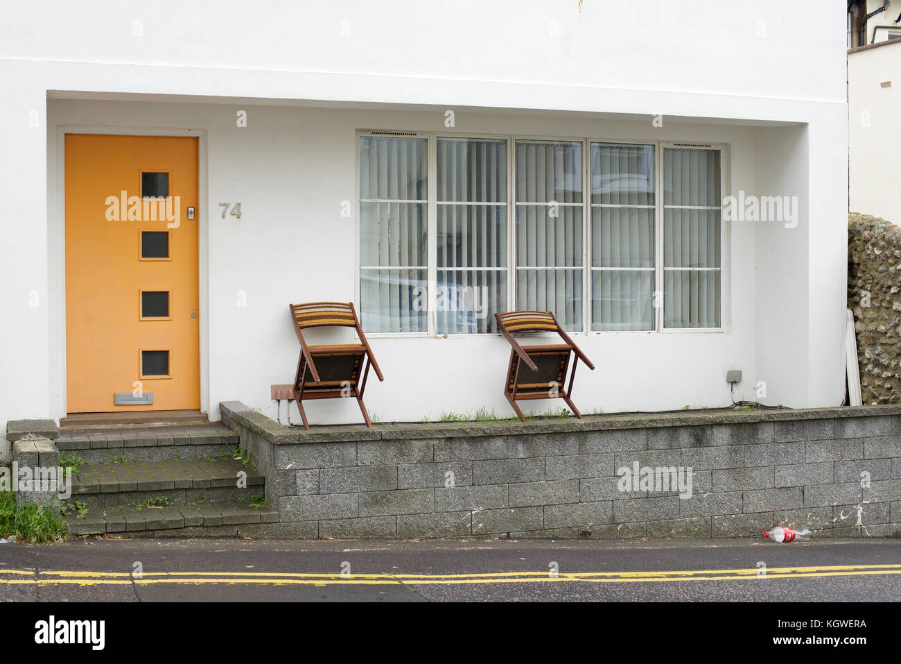 Front of a house with two chairs Stock Photo - Alamy