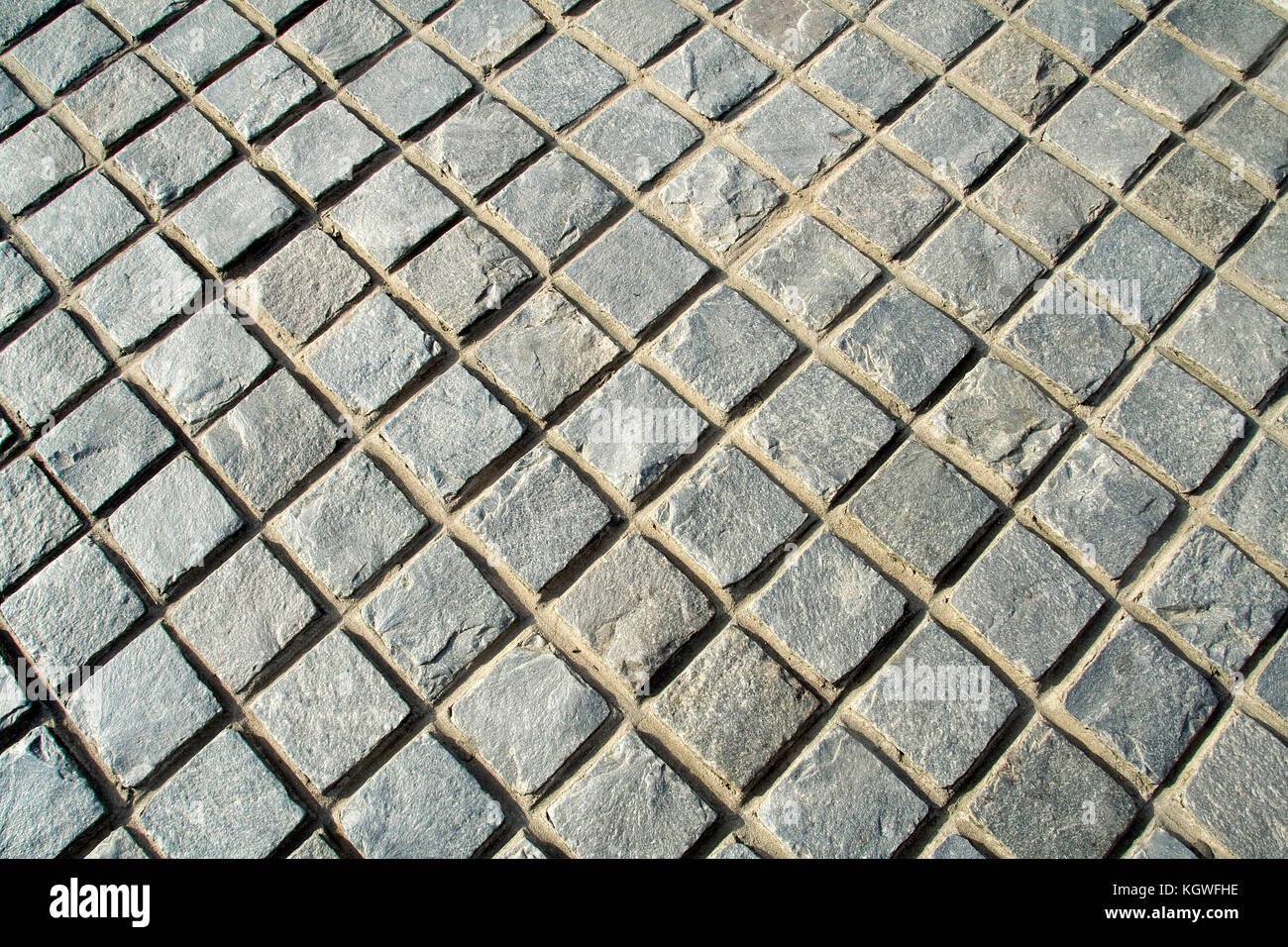 Diagonal view of pattern of checked stone pavement Stock Photo - Alamy